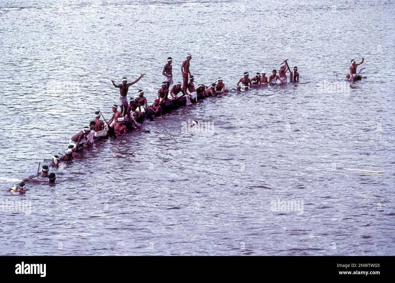 Participants on a sunken boat at Aranmula boat race during Onam ...