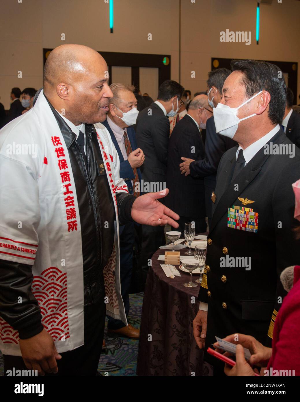 Capt. David Adams, Commander, Fleet Activities Sasebo (CFAS), speaks with Japan Maritime Self ...