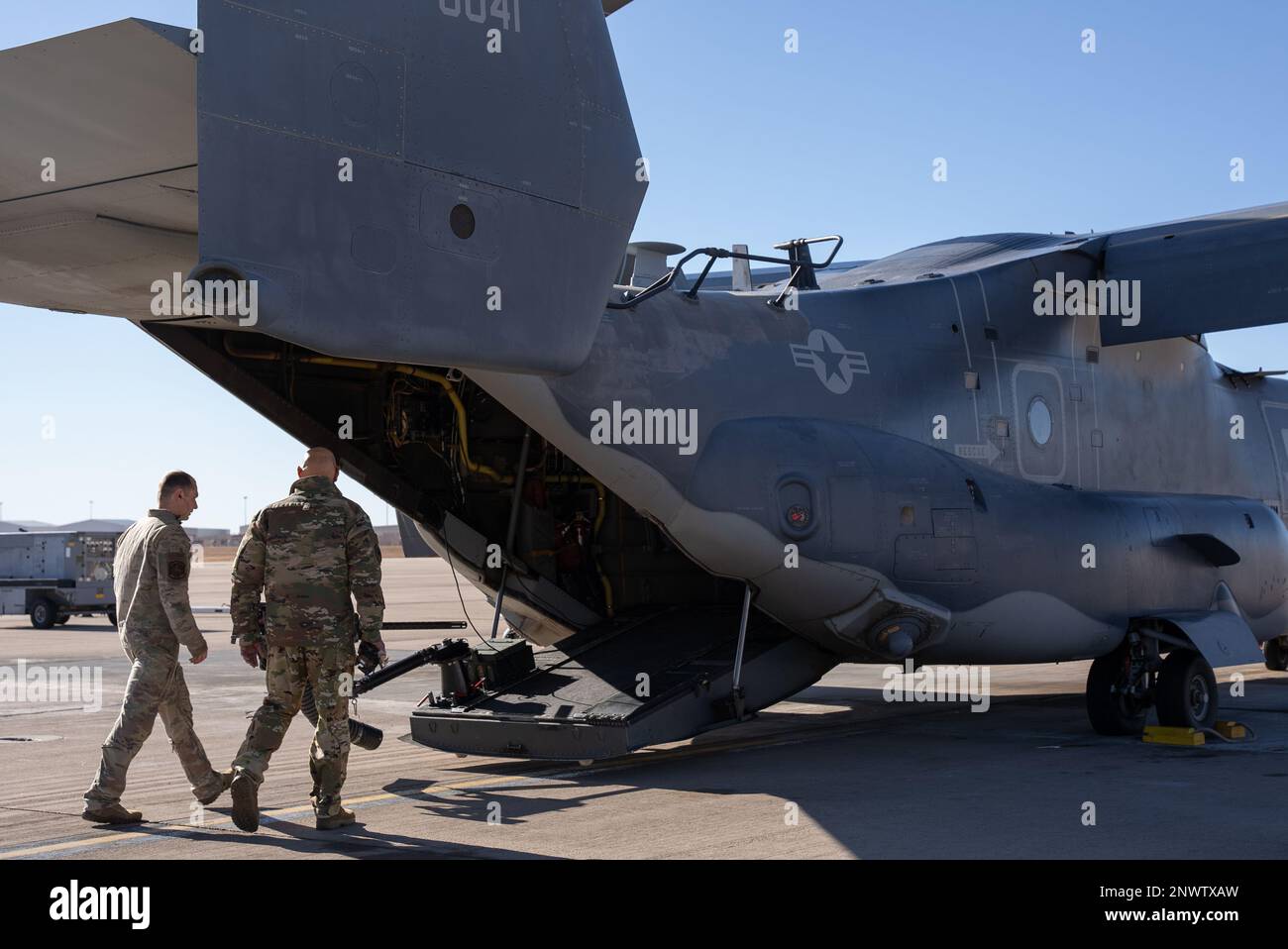 U.S Air Force members walk towards a CV-22 Osprey assigned to the 20th ...