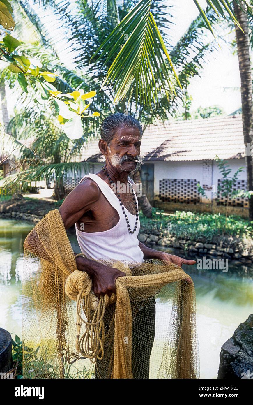 A man with fishing net, Backwaters of Alappuzha Alleppey, Kerala, South ...