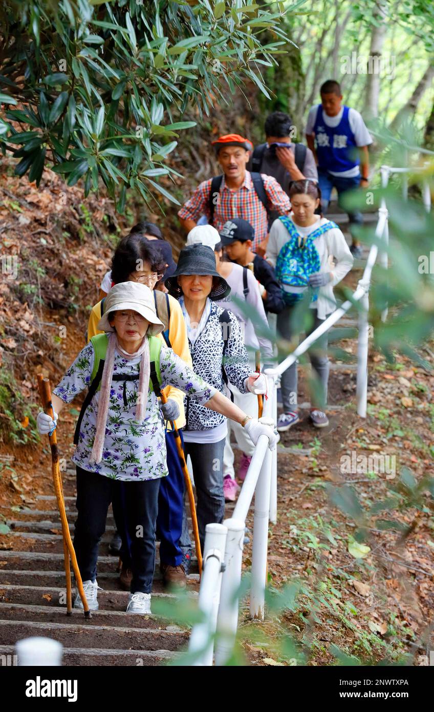Bereaved family and relatives climb a mountain to pray for the victims ...