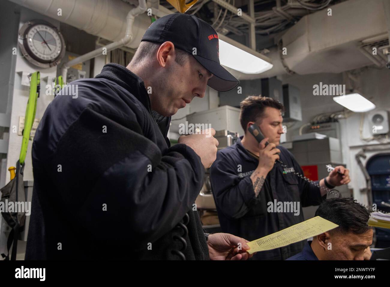 230212-N-YR119-1025 Lt. Jake Robinson, left, reports a simulated ...