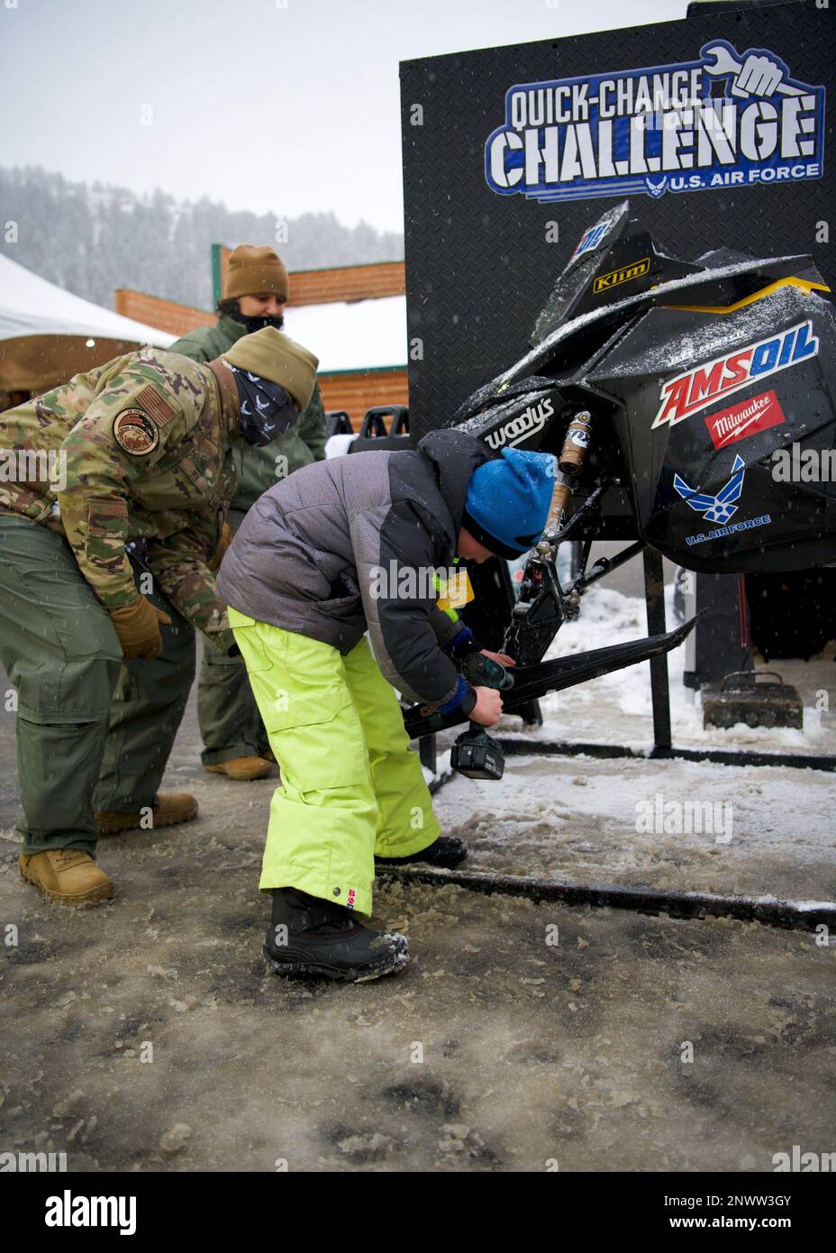 A spectator participates in the Air Force Quick-Change Challenge, while ...