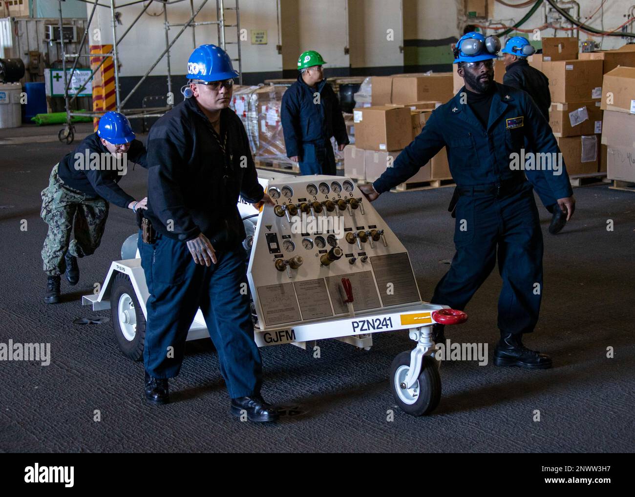 Sailors load a nitrogen cart aboard the Nimitz-class aircraft carrier ...