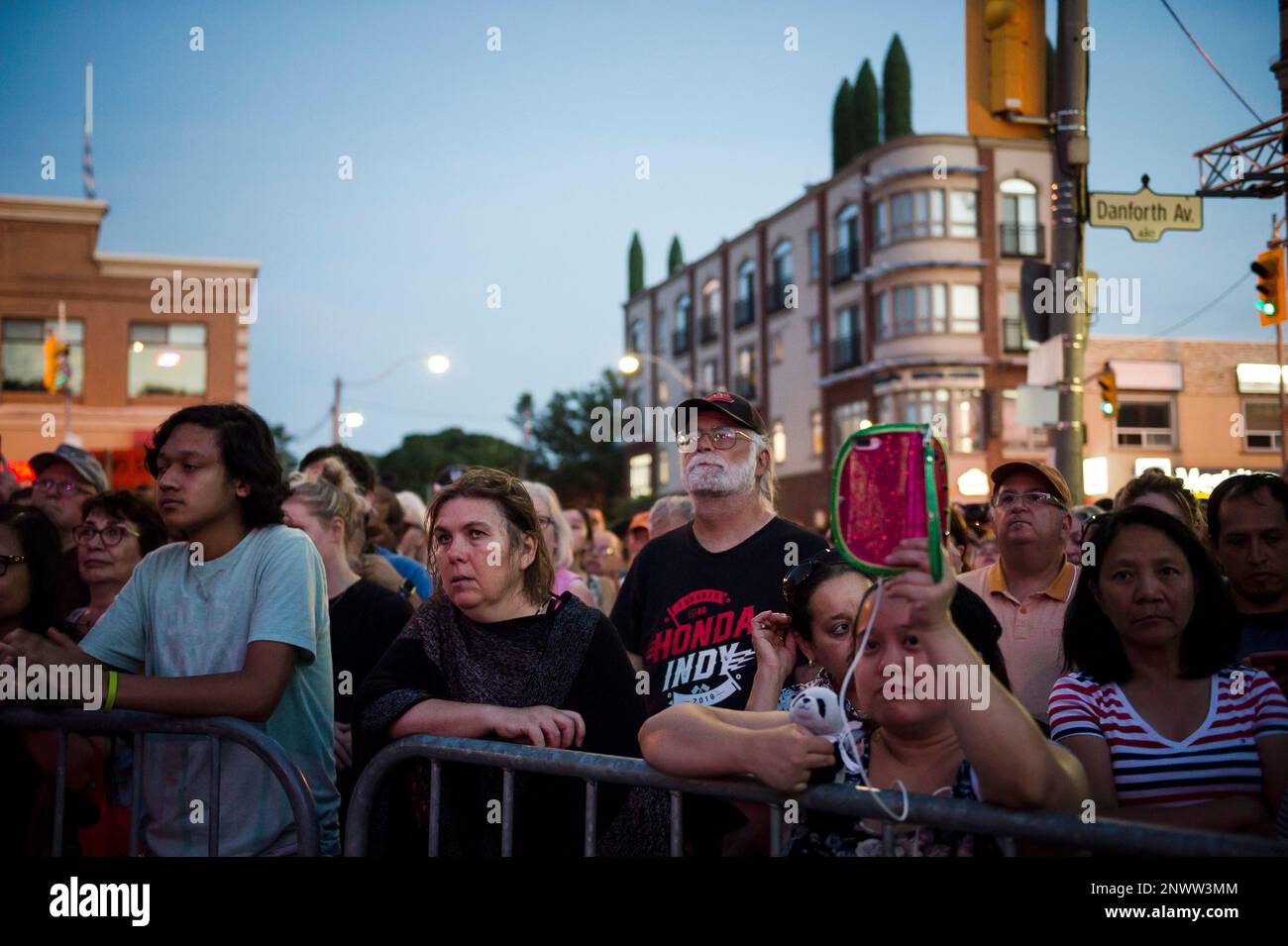 People gather to watch Canadian Prime Minister Justin Trudeau and other dignitaries ring in the ...