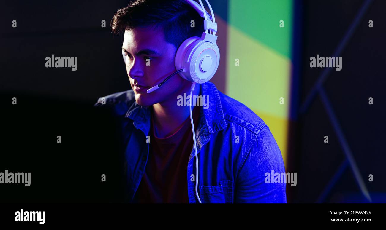 With his headset on and game streaming in full swing, a young gamer is ...