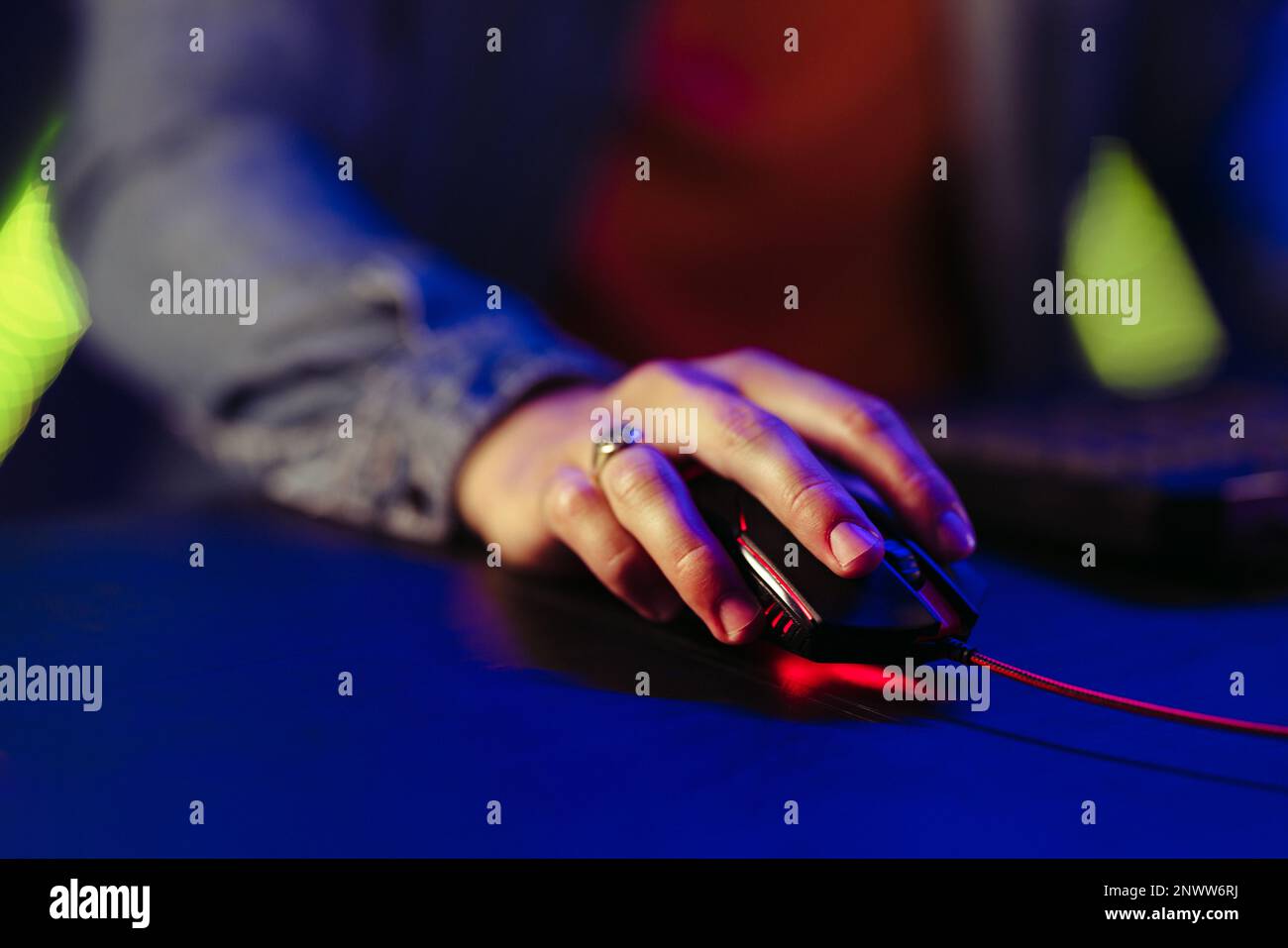 Gamer's hand navigating a mouse on a high-performance gaming computer ...