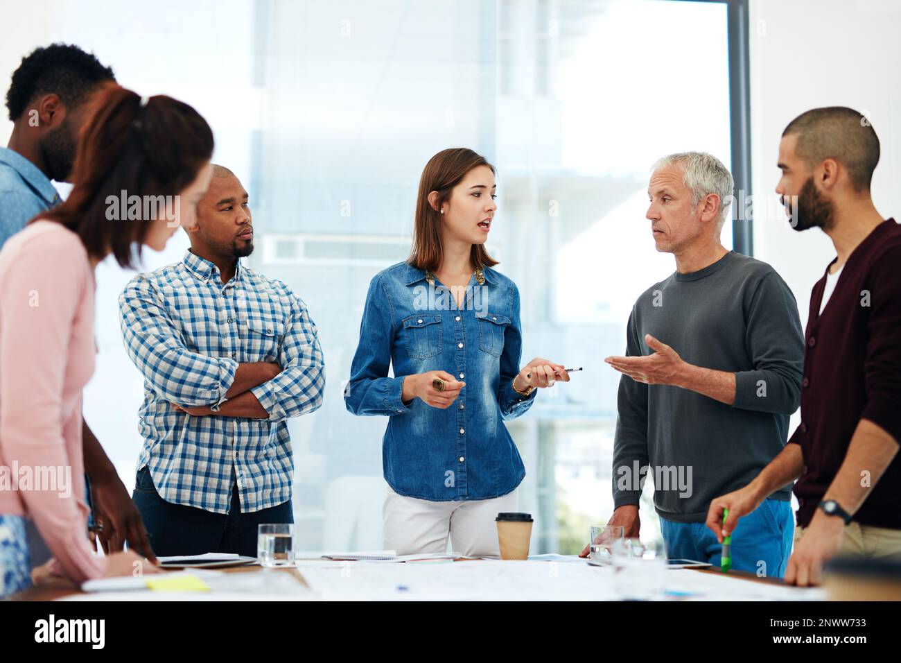 Bouncing ideas off of one another. a group of architects working on ...