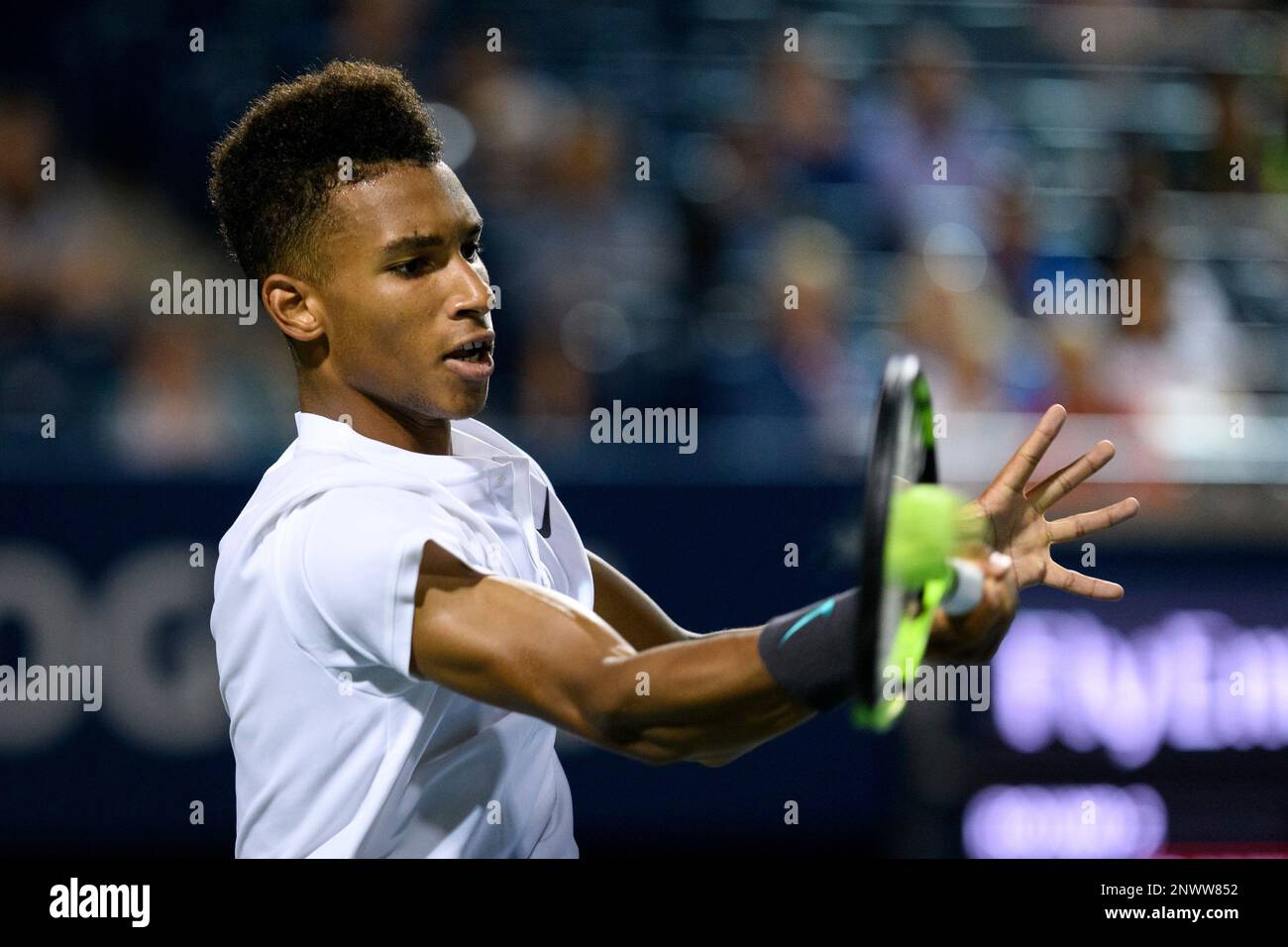 TORONTO, ON - AUGUST 08: Felix Auger-Aliassime (CAN) returns the ball during his second round ...