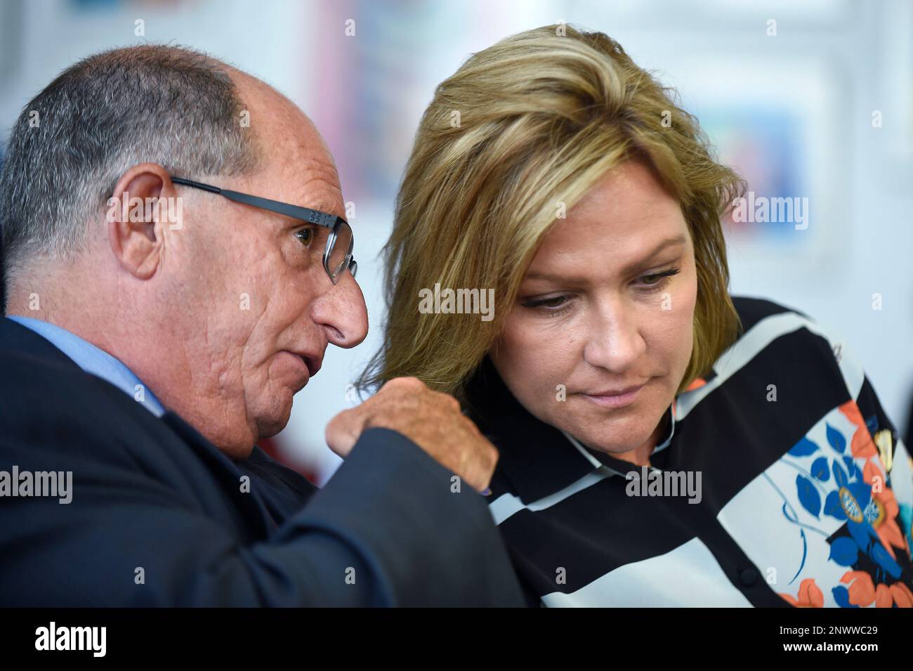 Valerie Santilli, right, leans in to listen to her husband, Lawrence ...