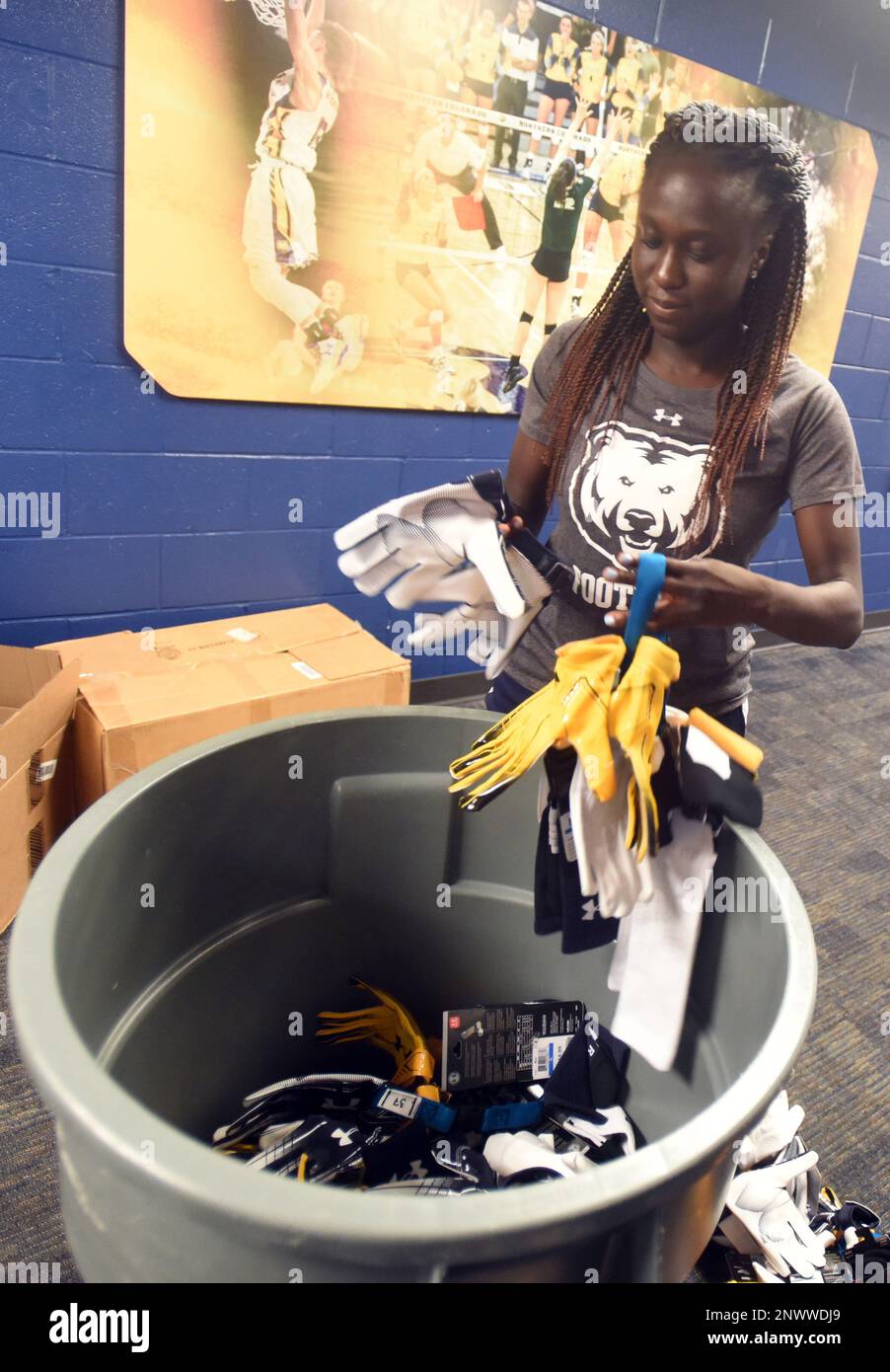 Tobi Ogunmodede sorts through gloves as she helps prepare for the ...