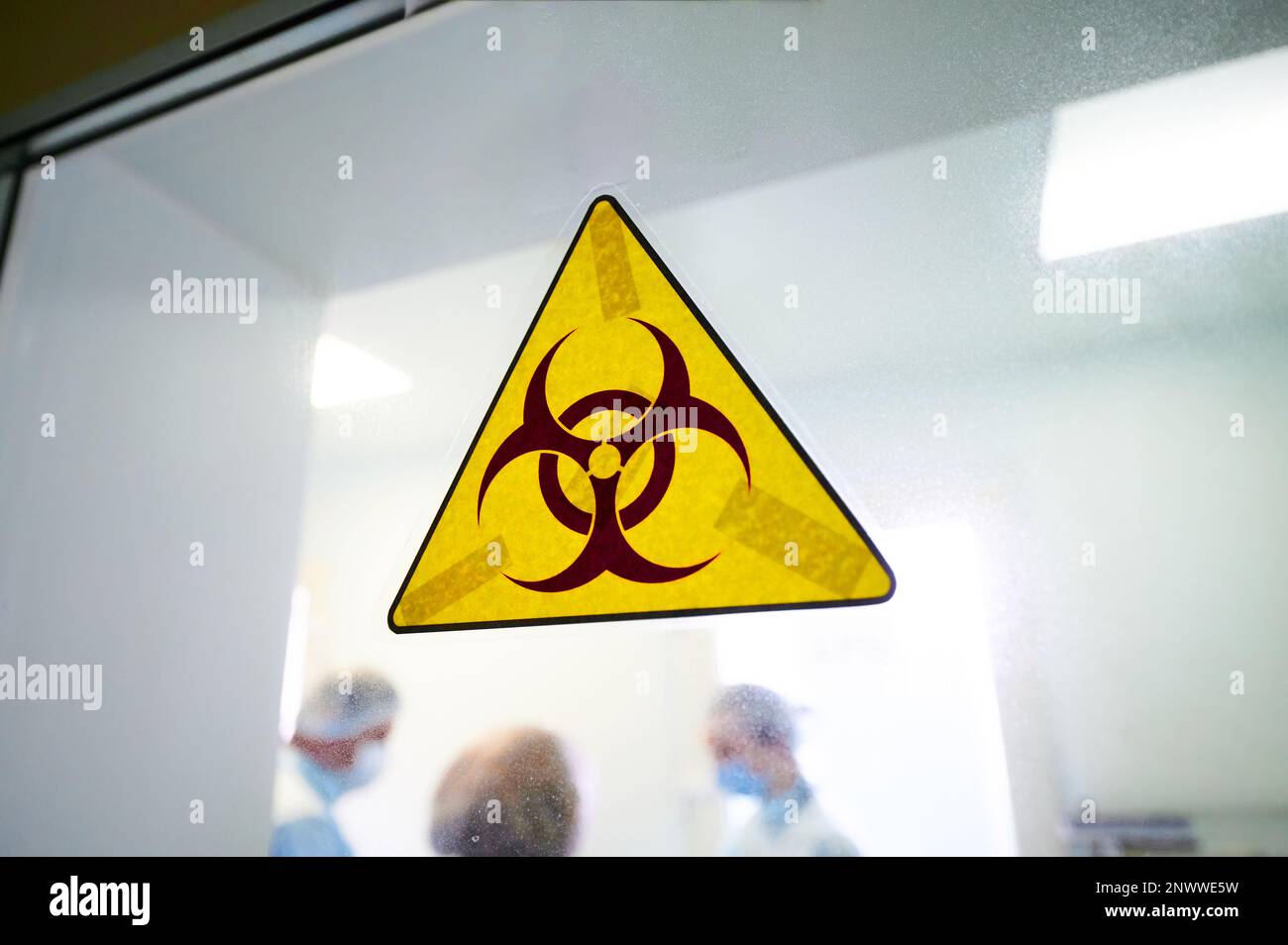 Biohazard warning sign on transparent laboratory door Stock Photo - Alamy