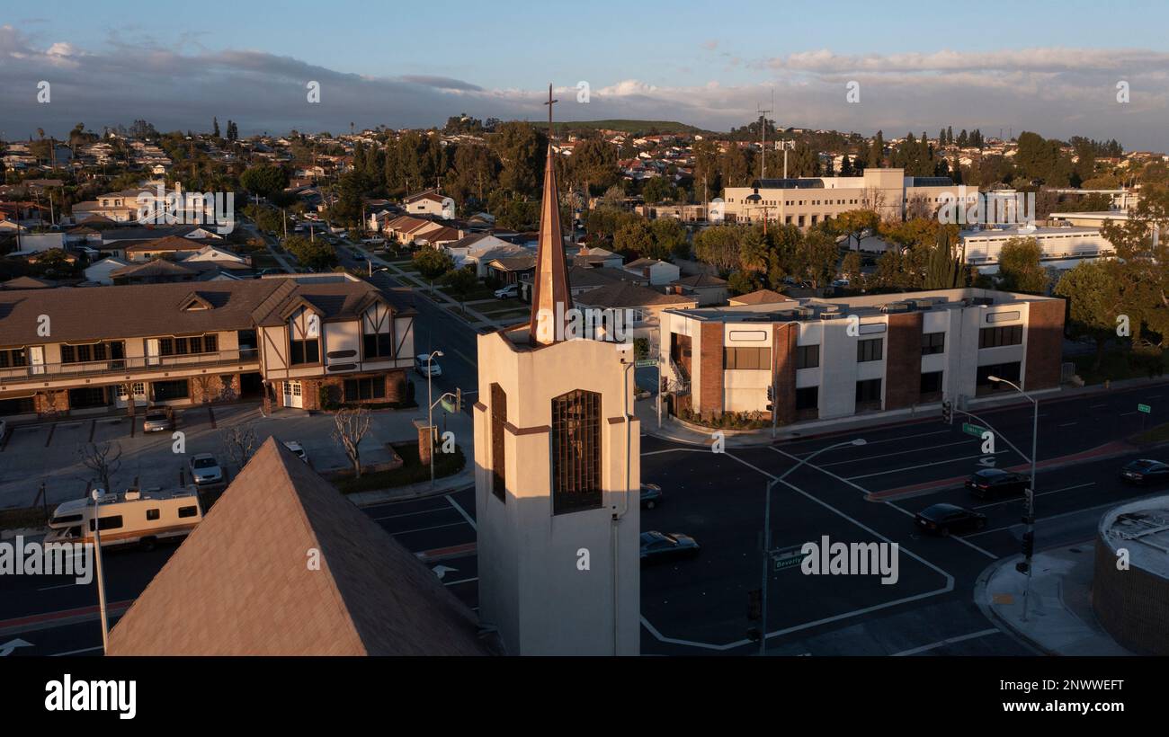 Sunset aerial view of a downtown church and surrounding city of ...