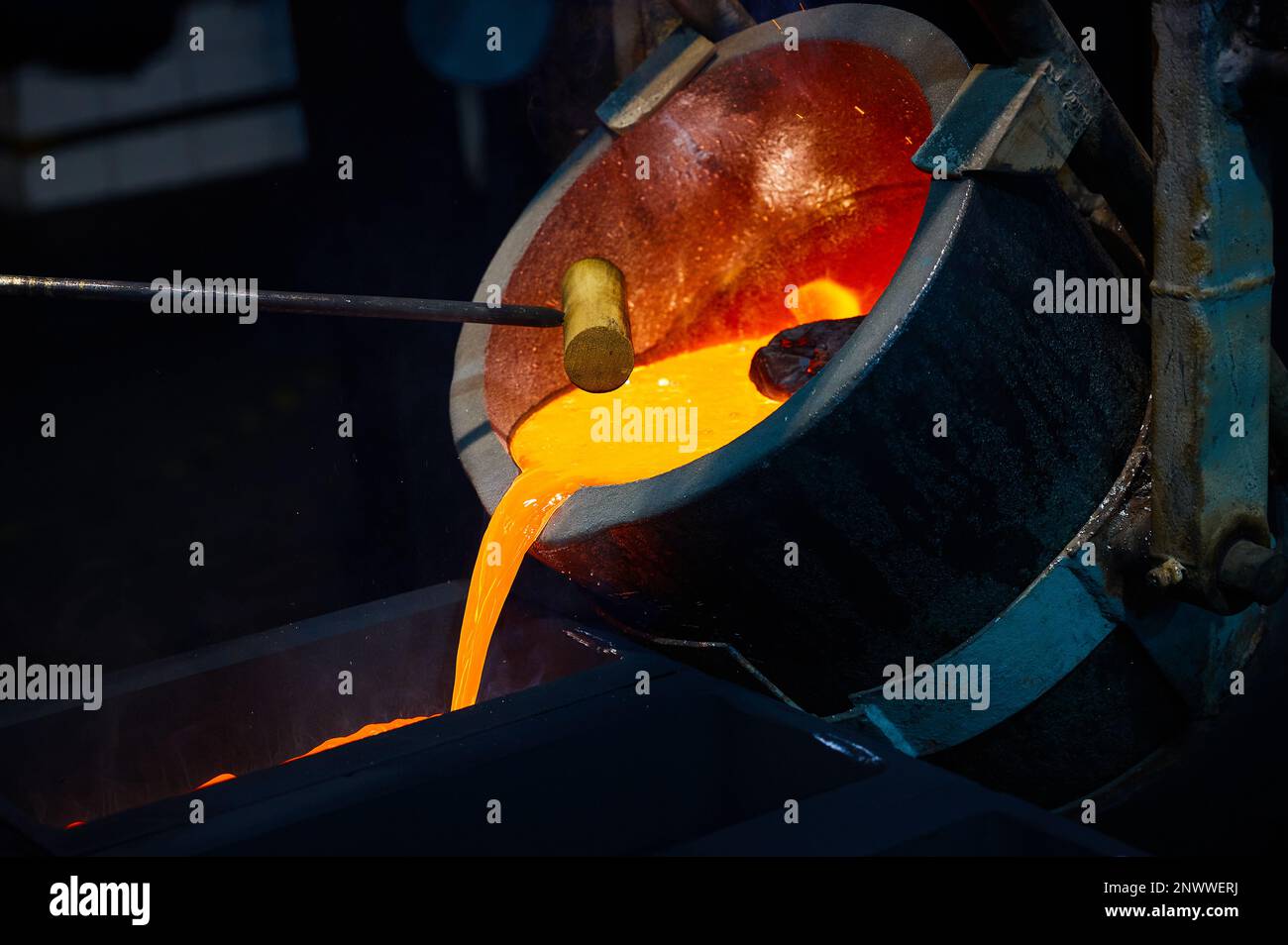 Pouring red liquid silver from bucket in induction oven Stock Photo - Alamy