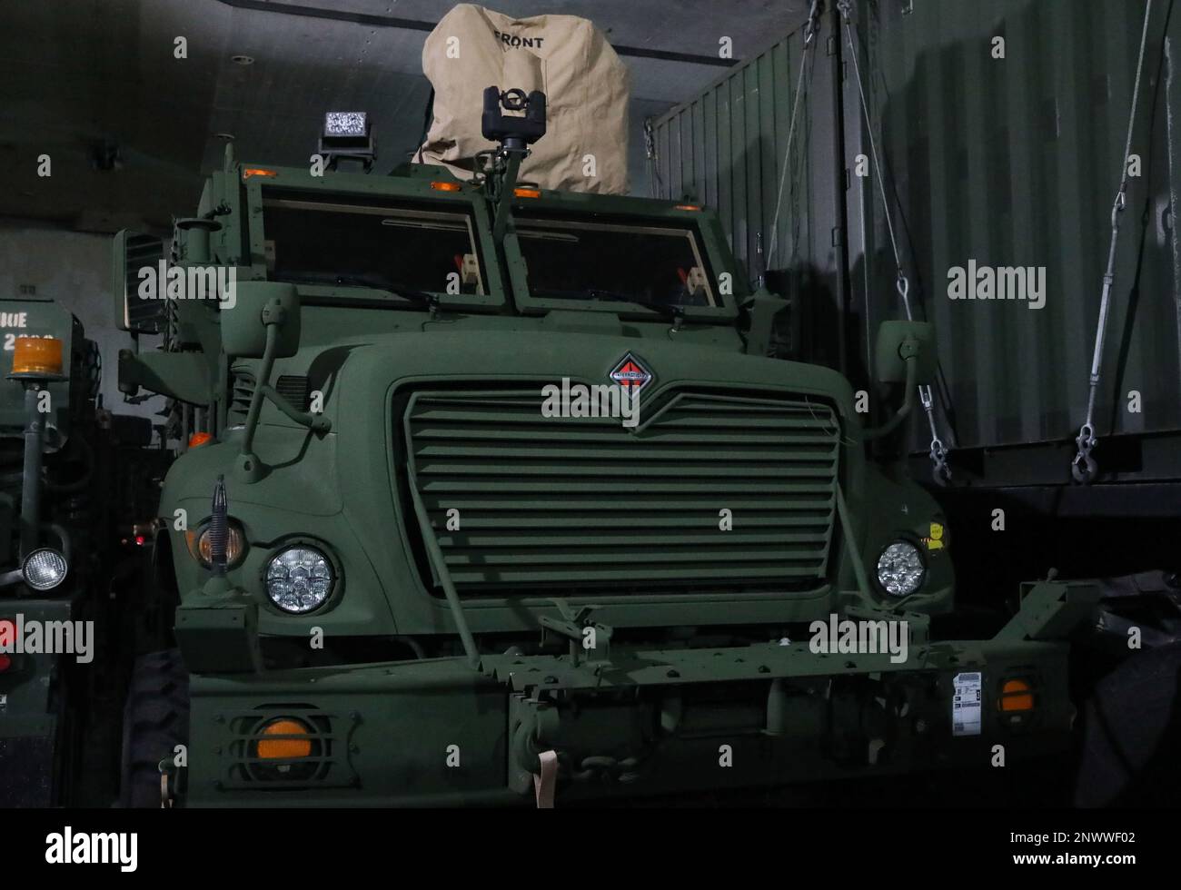 A Mine-Resistant Ambush Protected vehicle awaits inspection on the ship ...