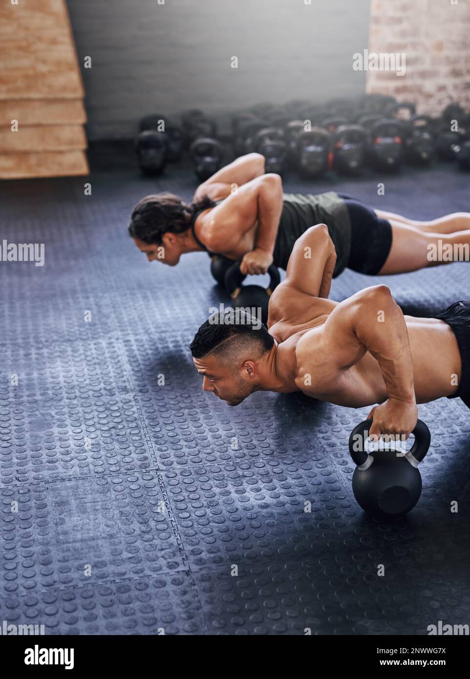 Striving for their fitness goals together. two young athletes working ...