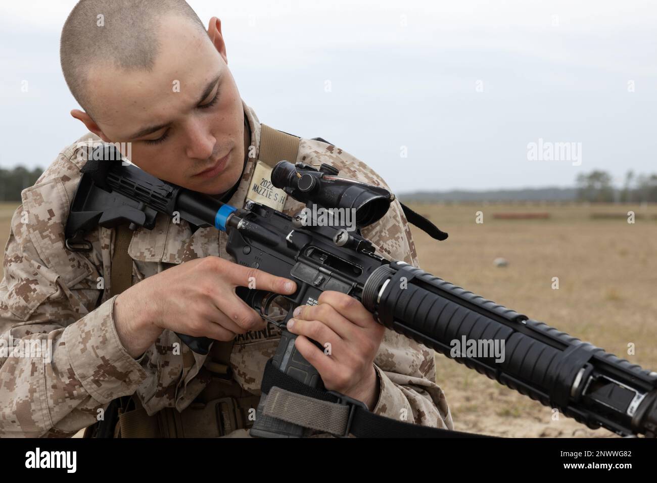 Recruit with Golf Company, 2nd Recruit Training Battalion, checks his M16A4 Service Rifle on ...