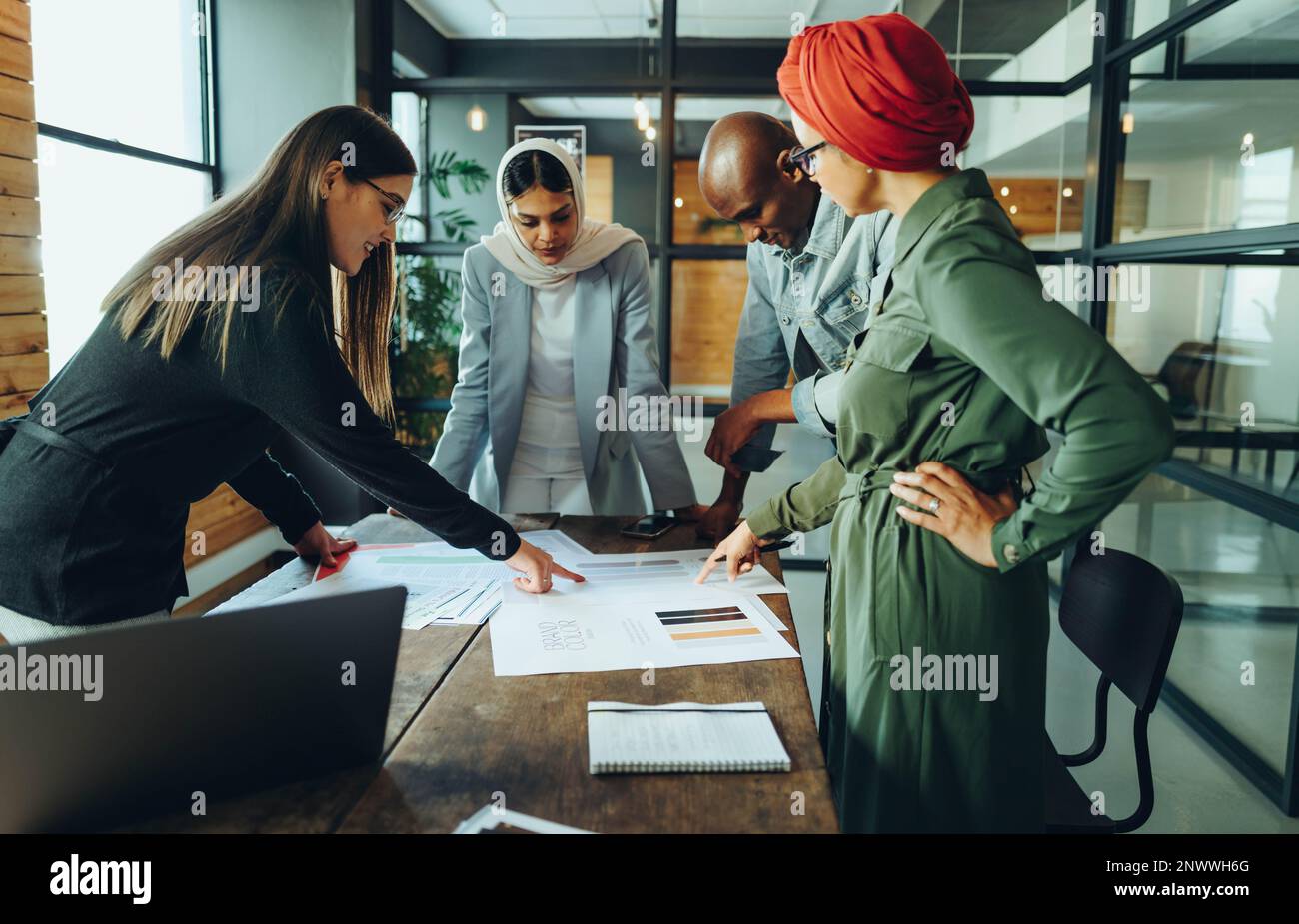Group of creative interior designers discussing colour palettes during ...