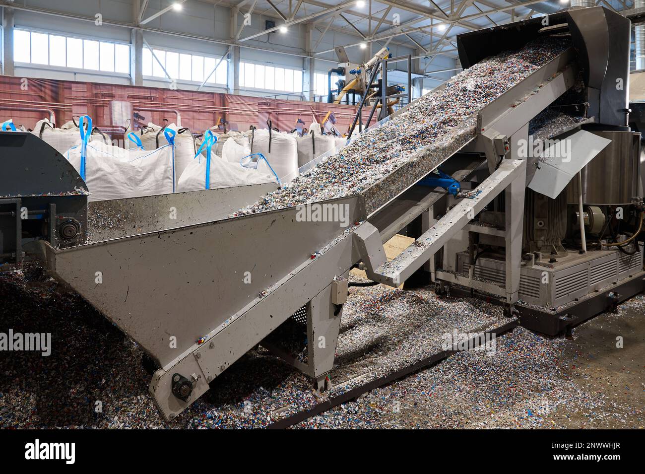 Chopped waste plastic transported by production line Stock Photo - Alamy