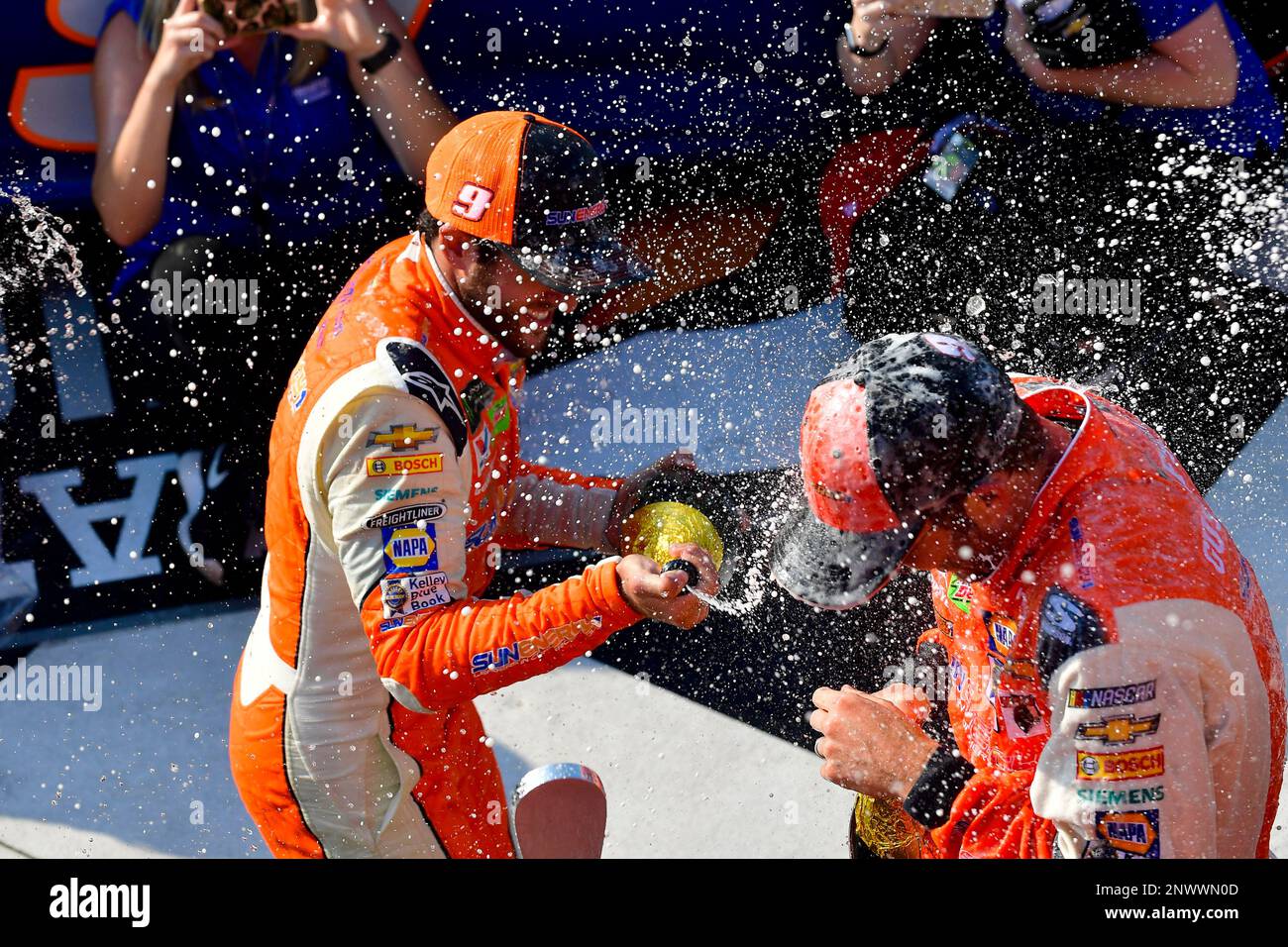 Chase Elliot (9) and crew chief Alan Gustafson celebrate with champagne ...