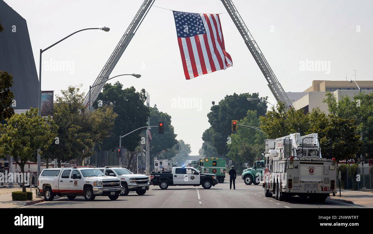 A fire truck procession from various agencies around the state caravans ...