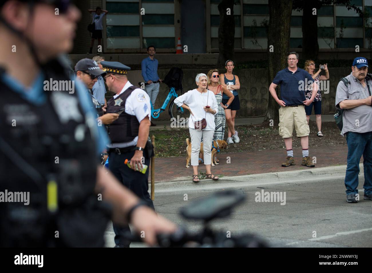 People watch as anti-violence protesters, led by Rev. Gregory Seal ...