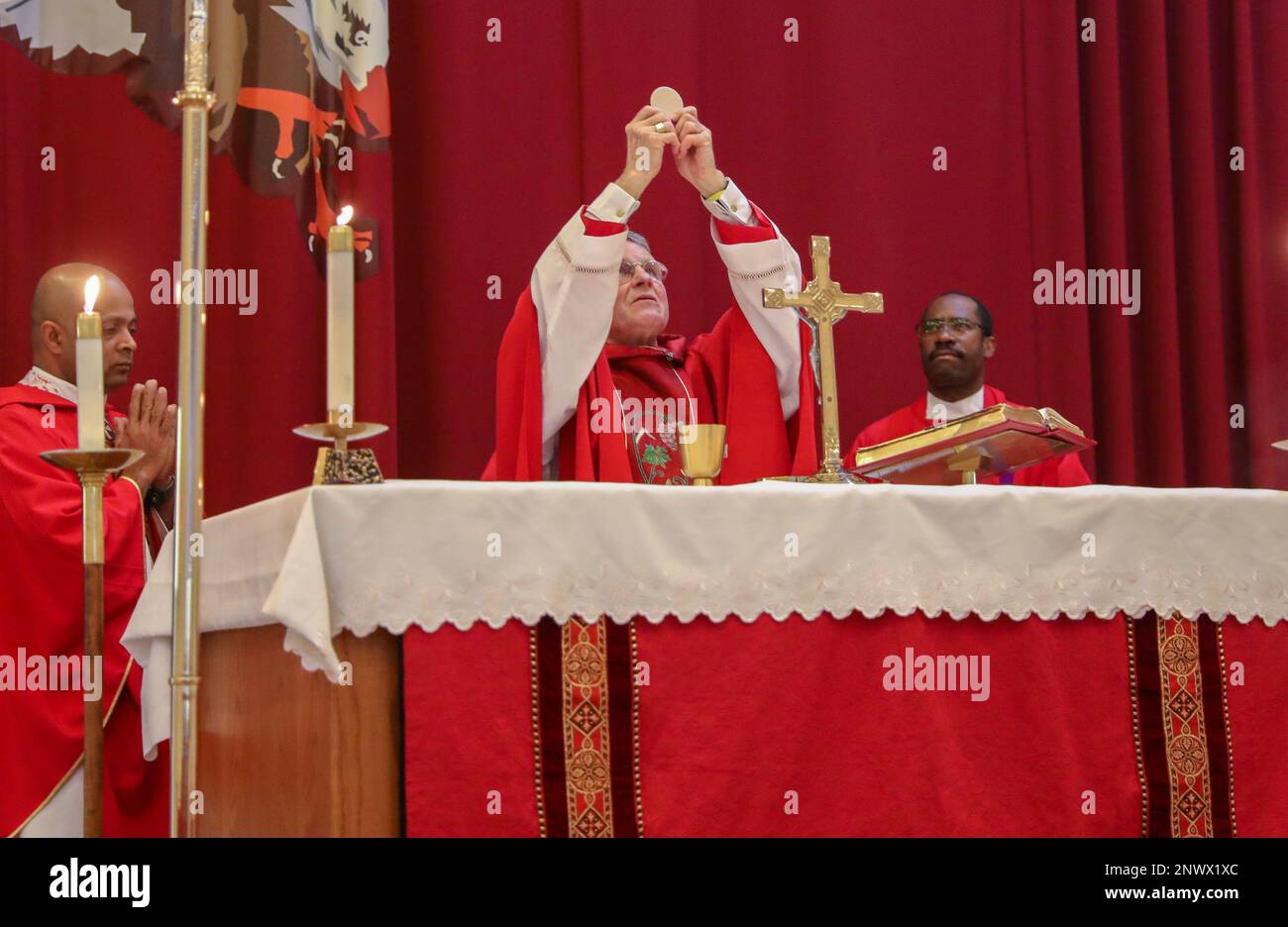 Roman Catholic Archbishop Timothy Broglio performs a transubstantiation ritual on unleavened ...
