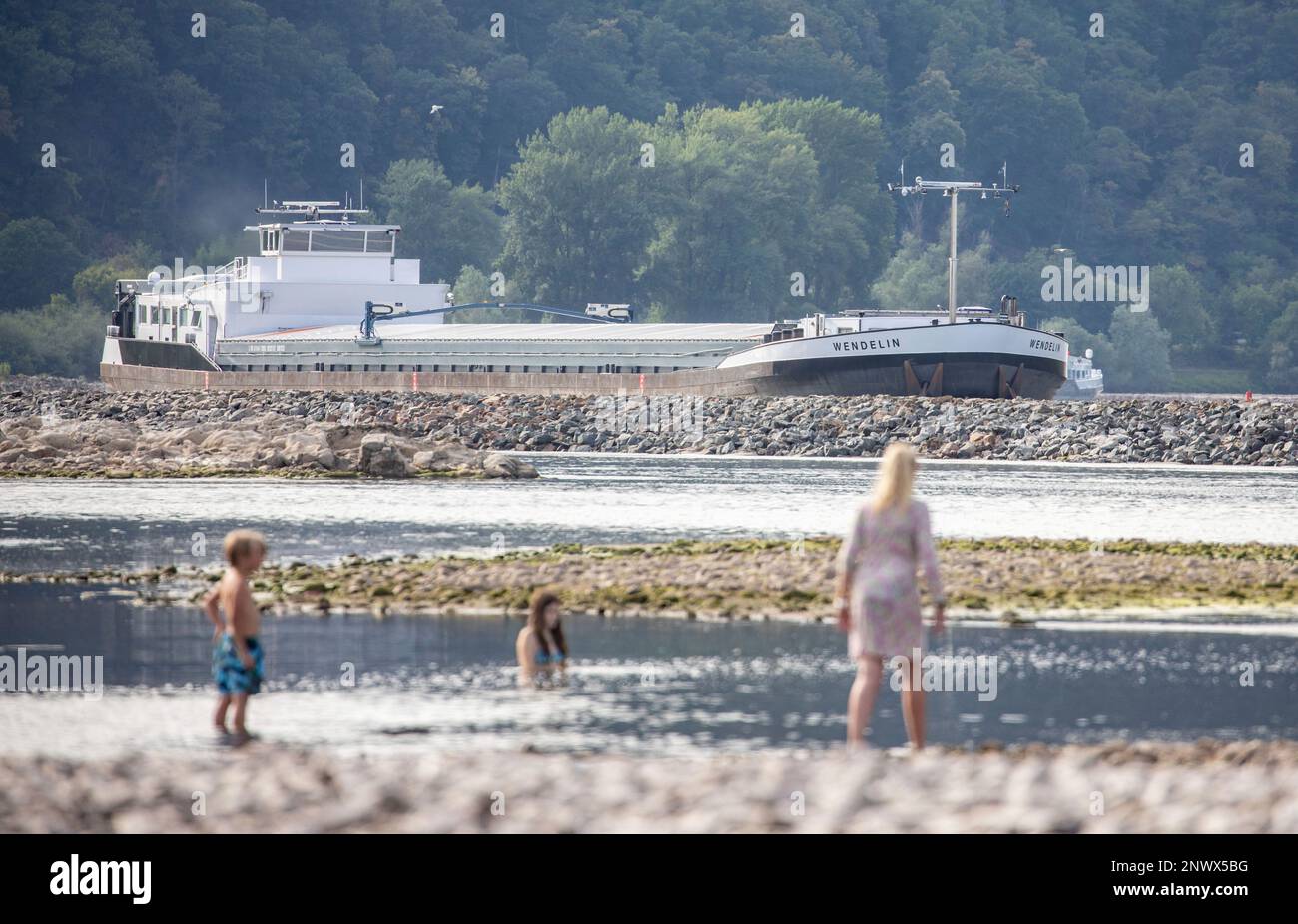 People play at the Rhine river that has lost a lot of water due to the ...