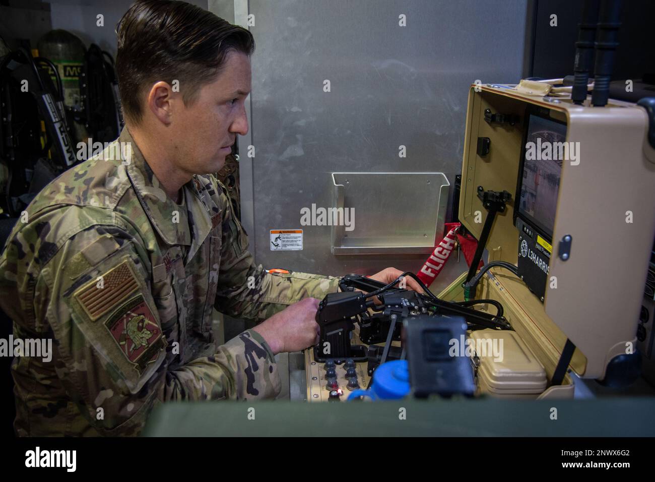 Senior Airman Devin Beedle operates the T7 robot during a demonstration ...