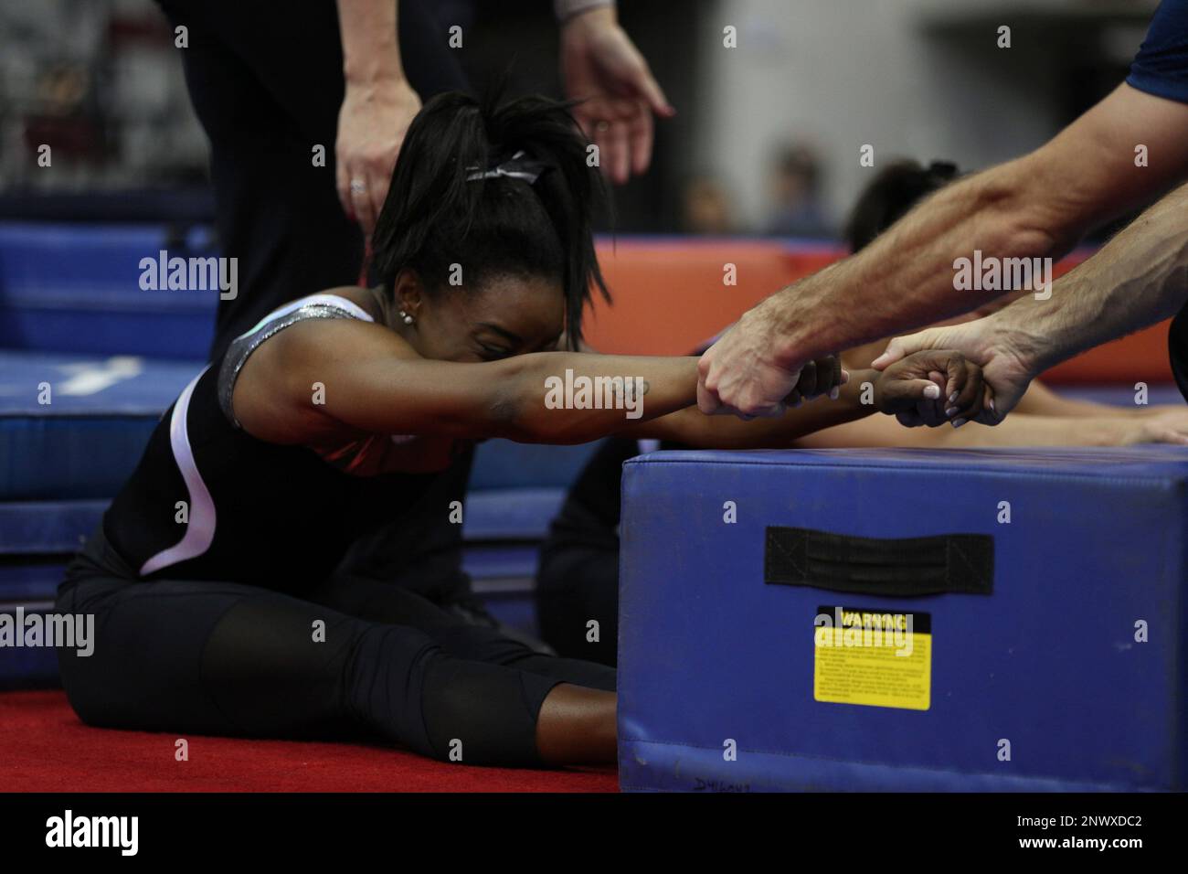 July 27, 2018: SIMONE BILES receives extra stretching from her coaches ...