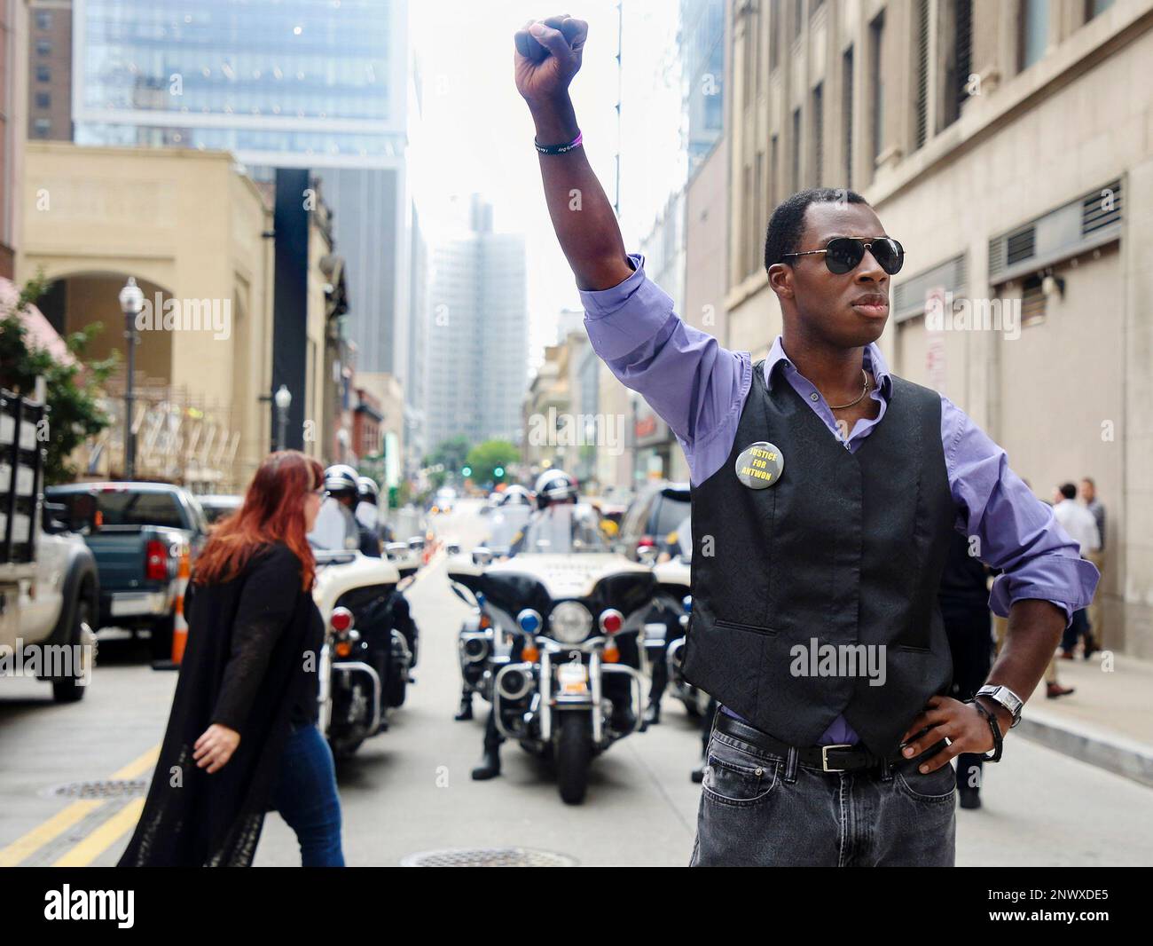 Jay Carter, 27, of the North Side of Pittsburgh, holds his fist high in ...