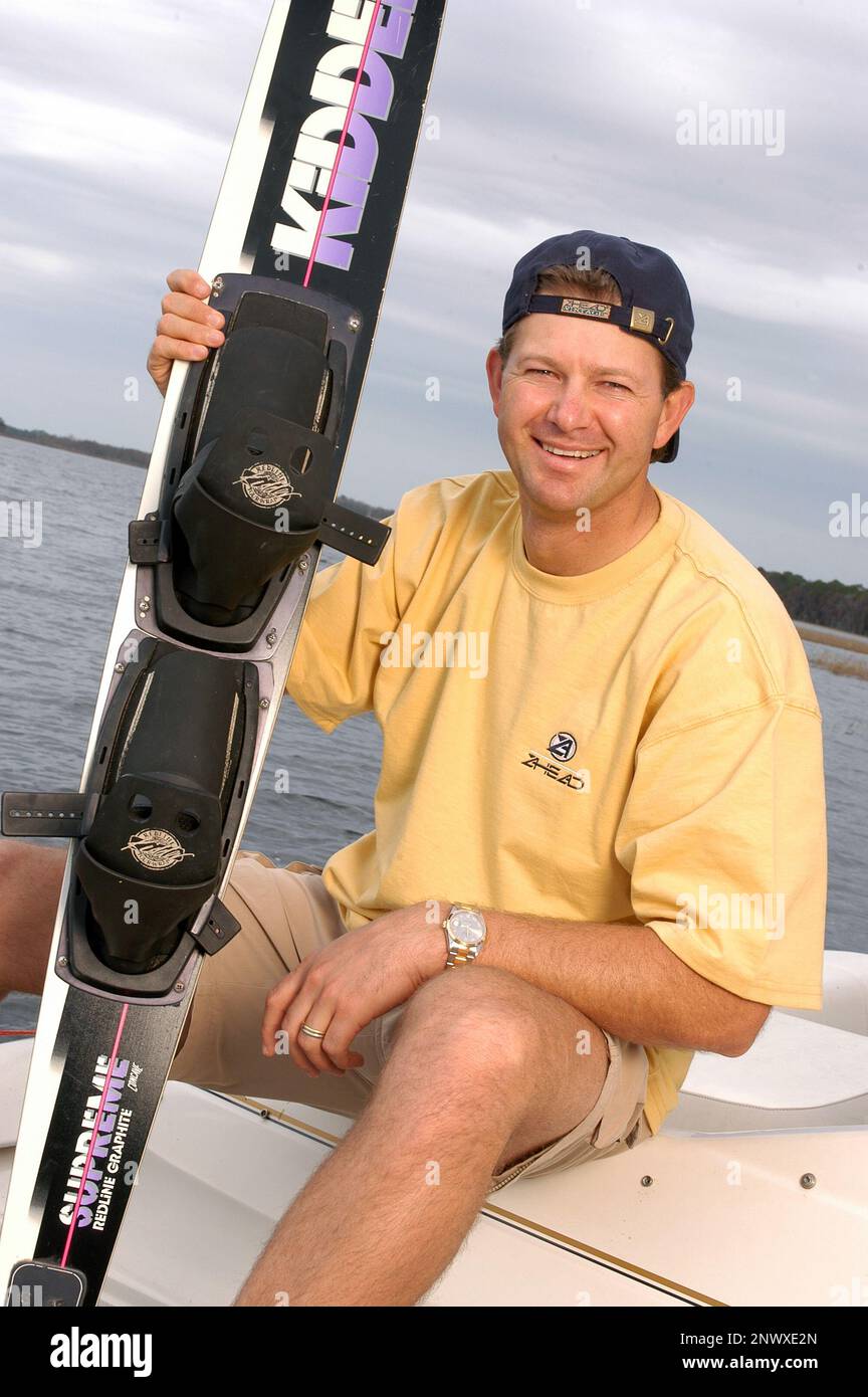 Professional golfer Retief Goosen stands on a boat dock at the edge of ...