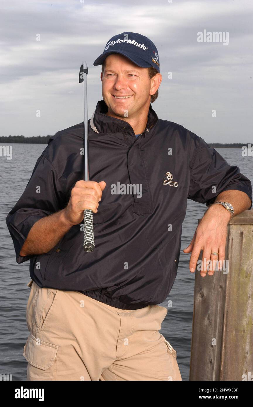 Professional golfer Retief Goosen stands on a boat dock at the edge of ...