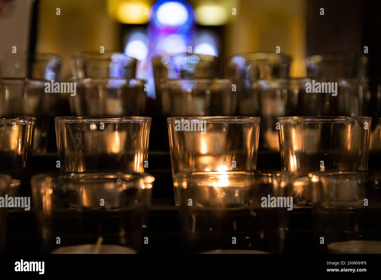 Atmospheric picture of lit candles at a prayer area inside a Catholic ...