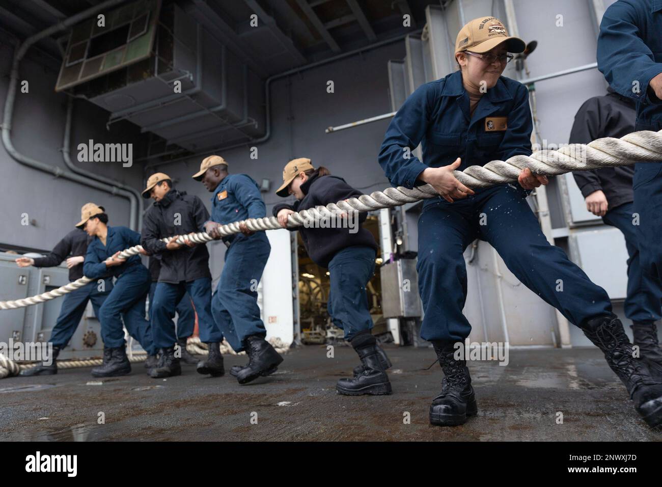 Sailors heave around lines on the fantail aboard the Nimitz-class ...
