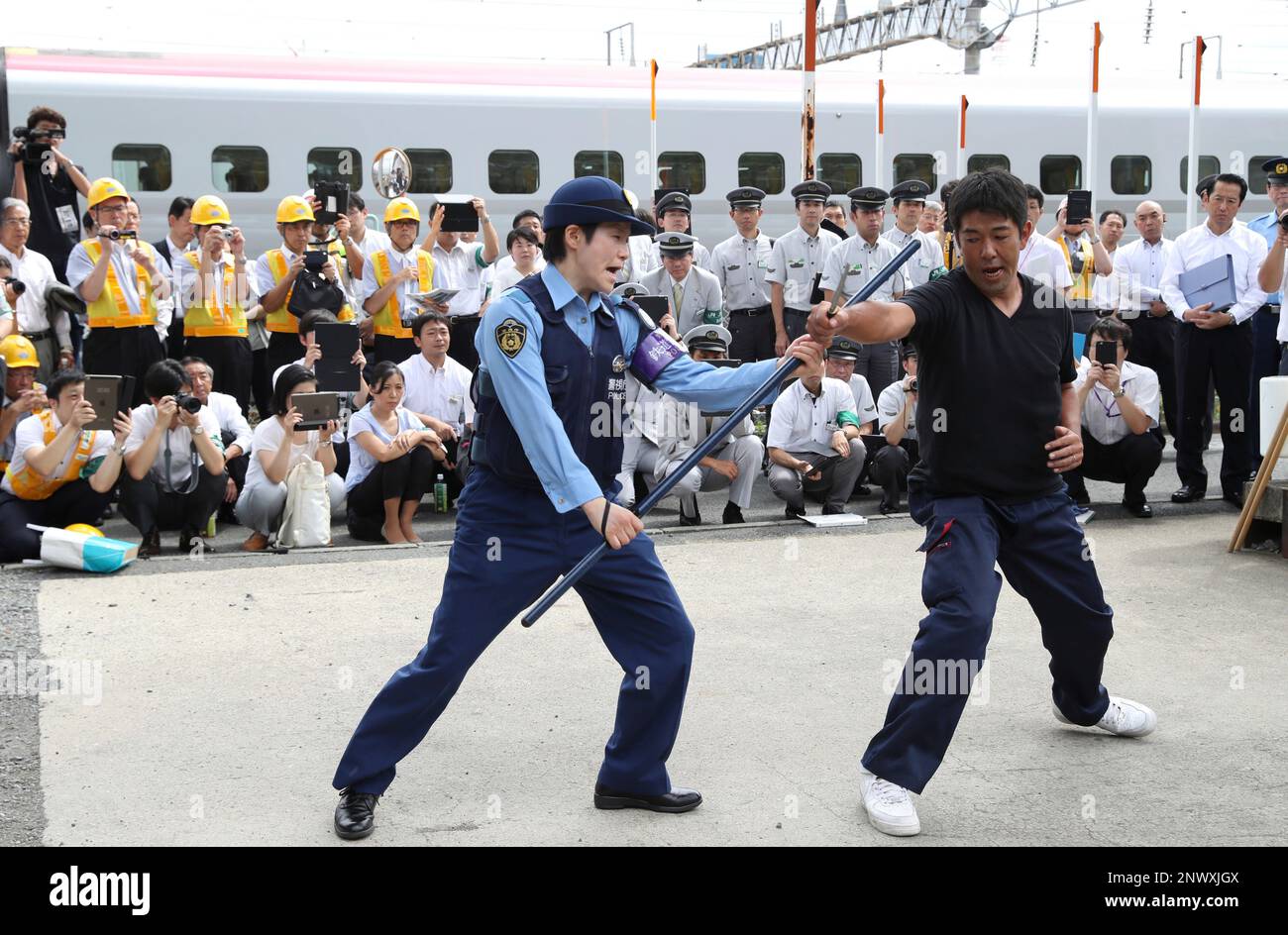 Police officers show hoe to use protection tools to East Japan Railway ...