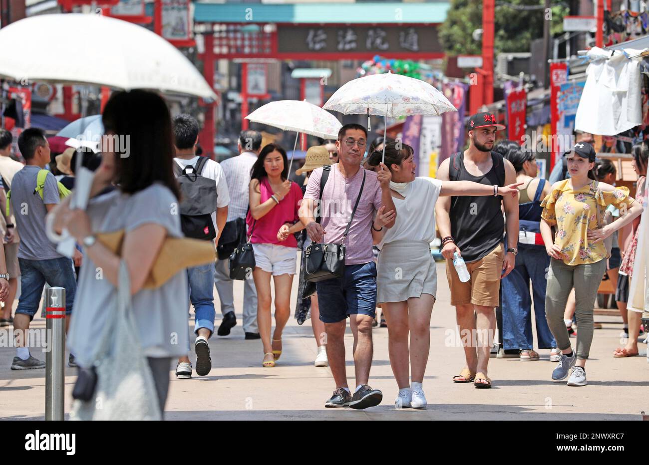 Foreign travelers go sightseeing in extreme heat at Asakusa District in ...