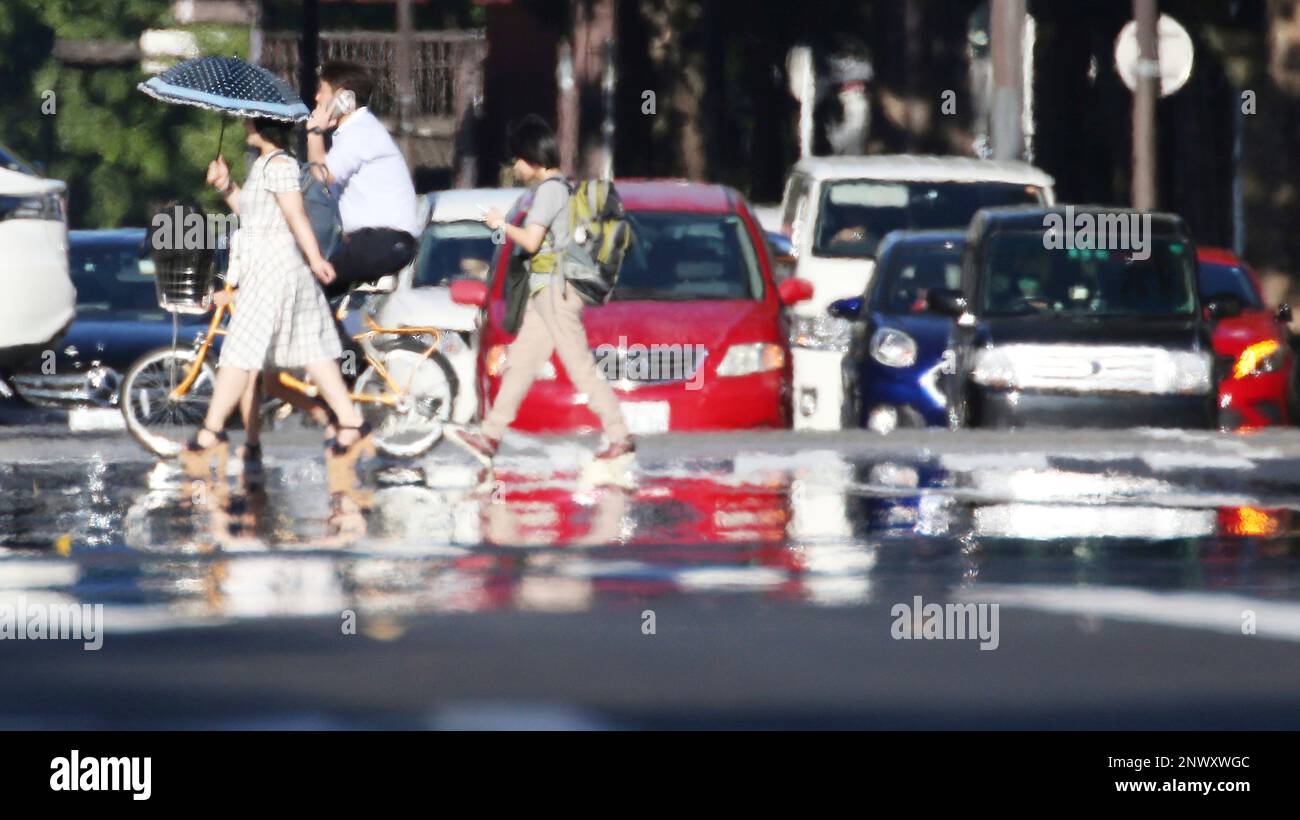 Road mirage is observed in hundred-degree weather in Nagoya City, Aichi ...