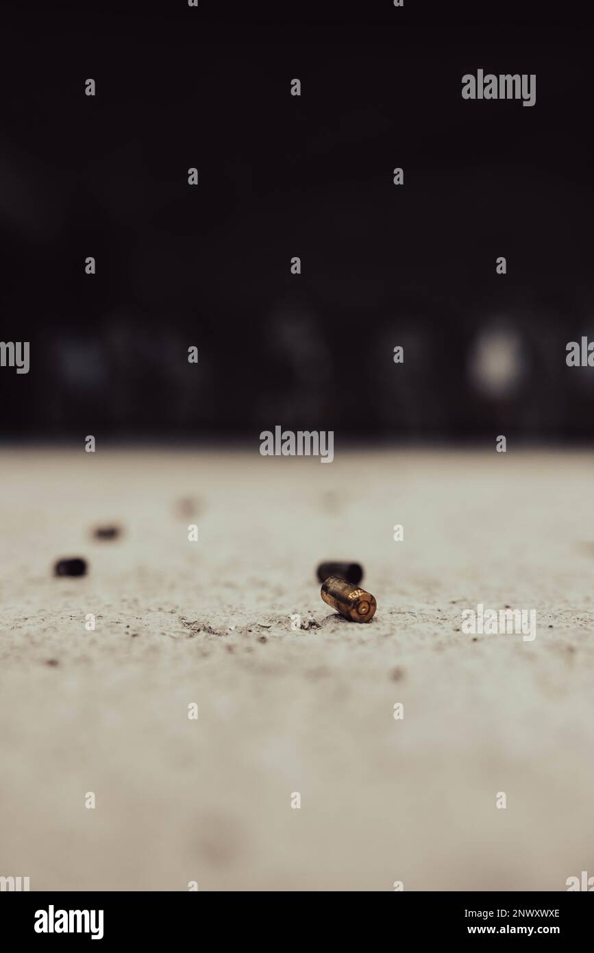 Spent brass casings of 9mm rounds lay on the ground after a live-fire ...