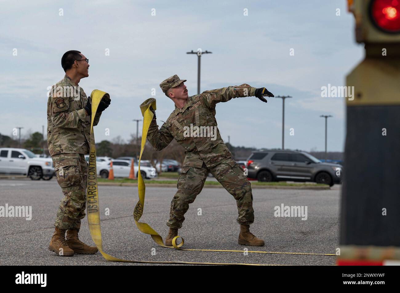 Two 633d Logistic Readiness Squadron Airmen throw tightening straps ...