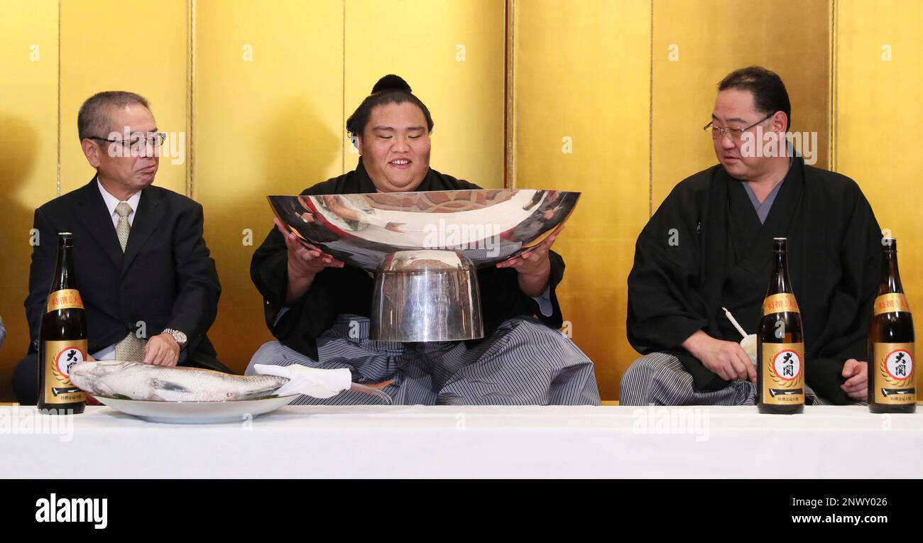 Japanese Sekiwake Mitakeumi (C) drinks Japanese wine Sake during the ...