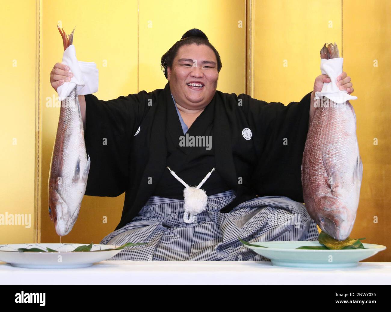 Japanese Sekiwake Mitakeumi holds sea breams during the celebration in ...