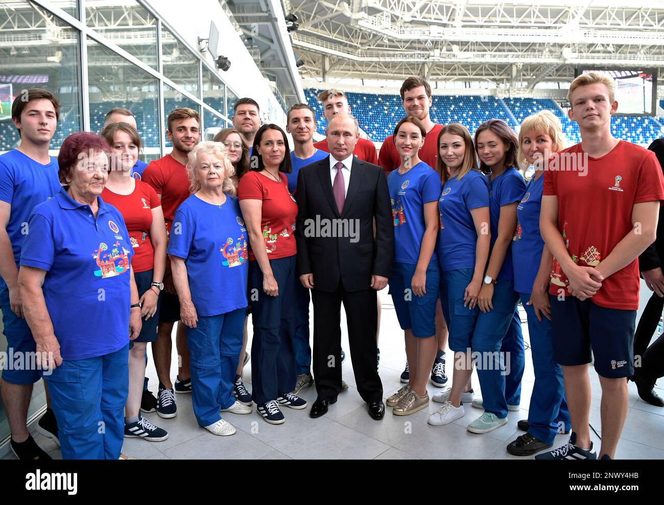 Russian President Vladimir Putin pose for a photo with volunteers while ...