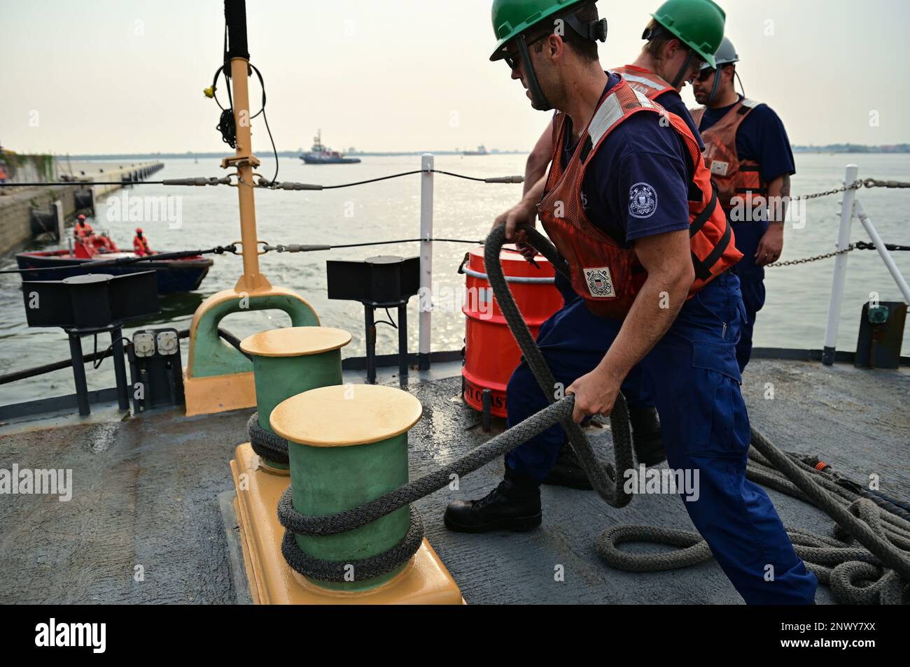 U.S. Coast Guard Seaman Gregory Seymoure works a line as USCGC Spencer ...