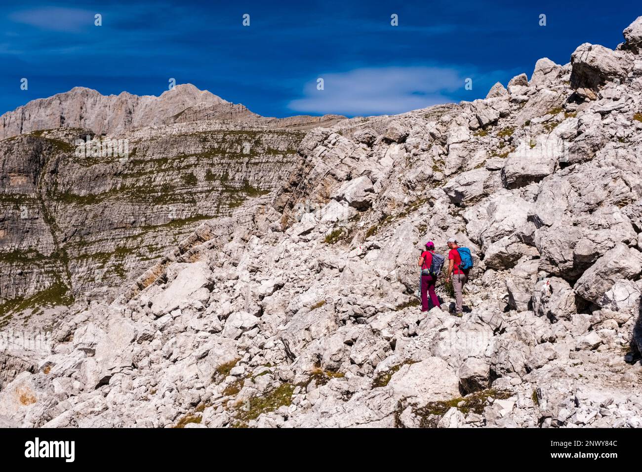 Two hikers walking on the path between the mountain hut Rifugio Francis ...