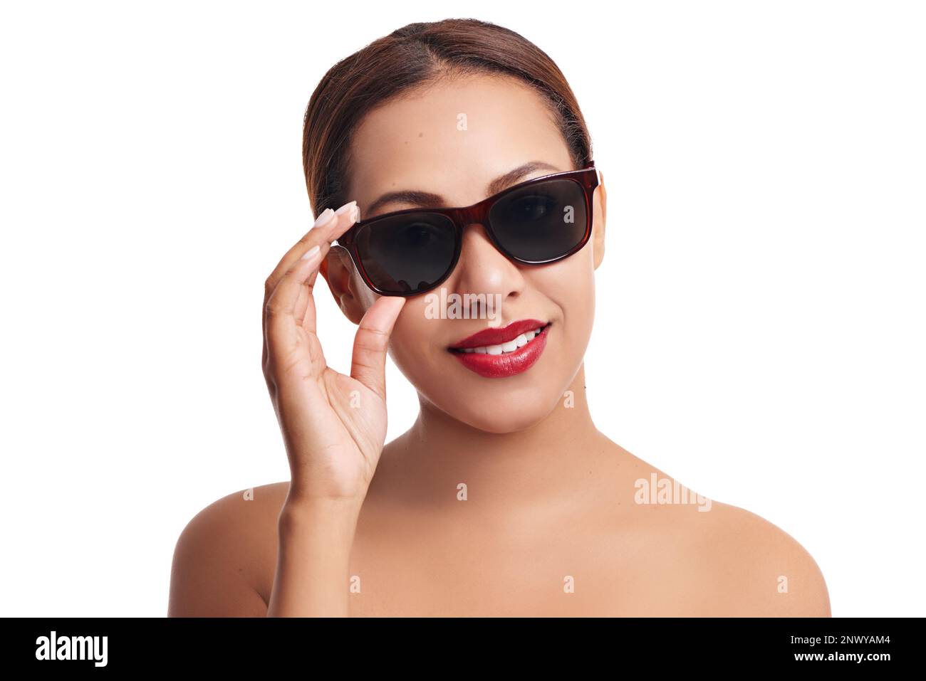 Loving her new shades. Studio shot of a young woman wearing sunglasses ...