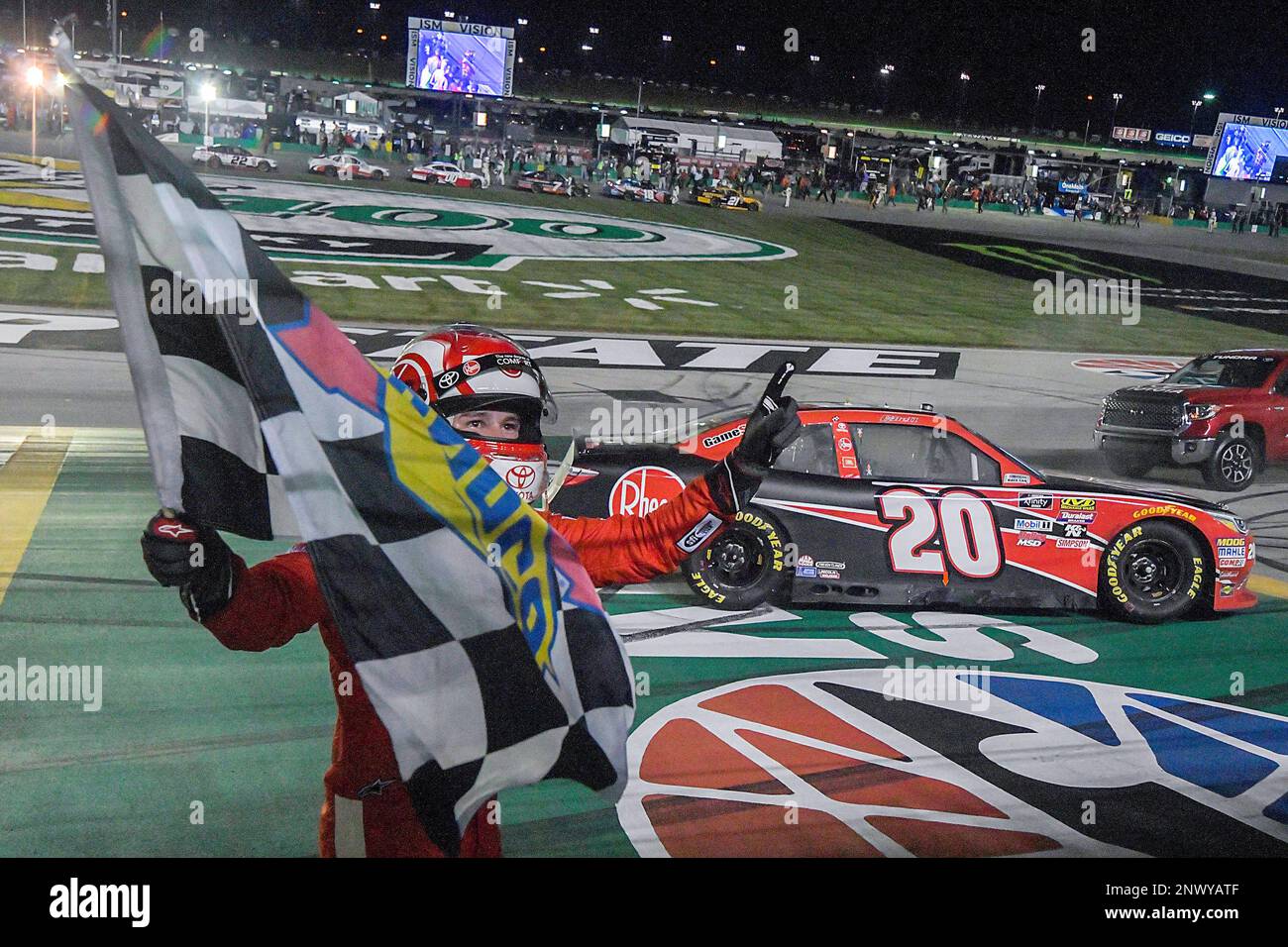 Christopher Bell (20) collects the checkered flag after the NASCAR ...