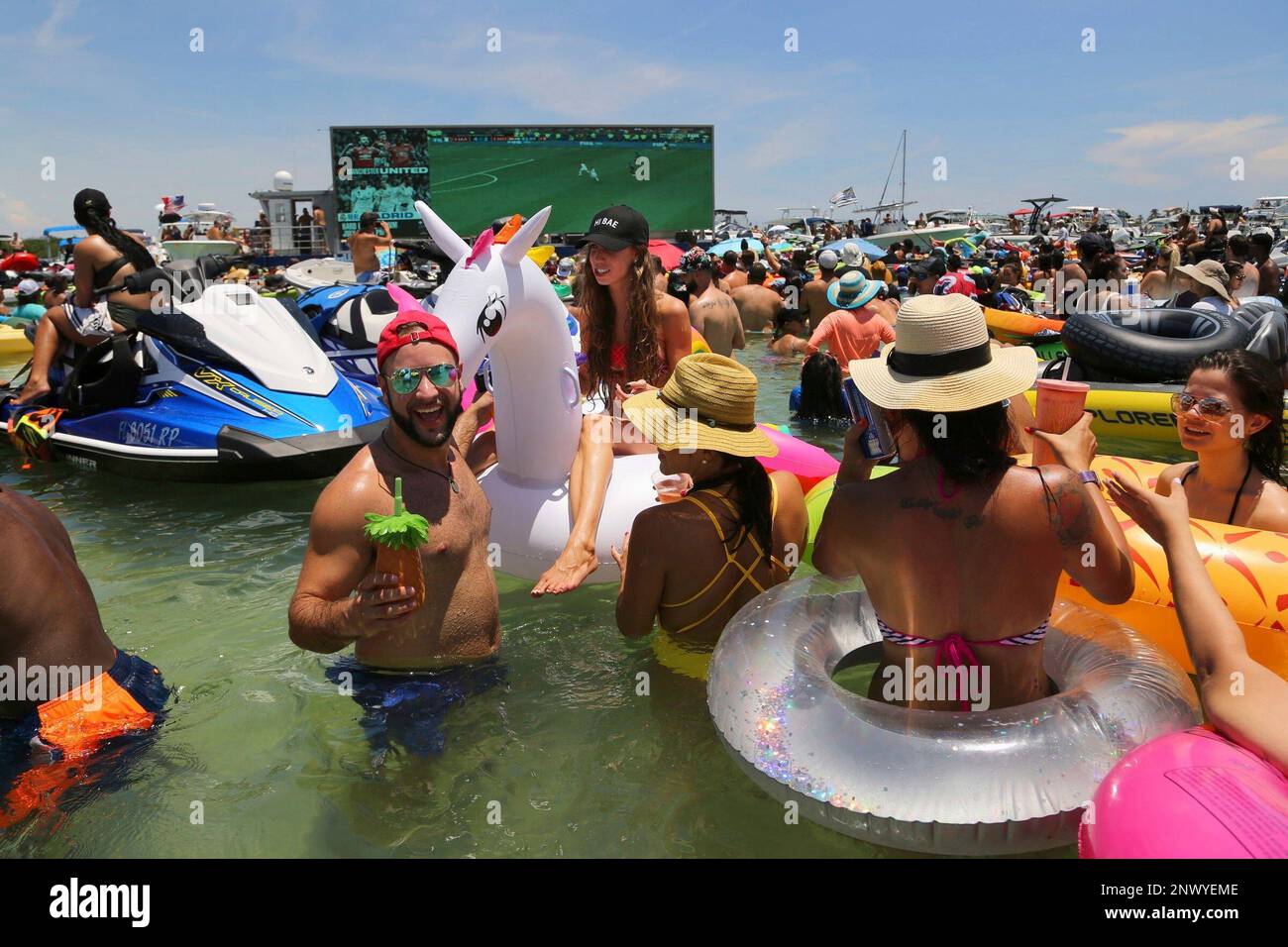 Soccer fans cool off in the water while they attending the "Ballyhoo ...