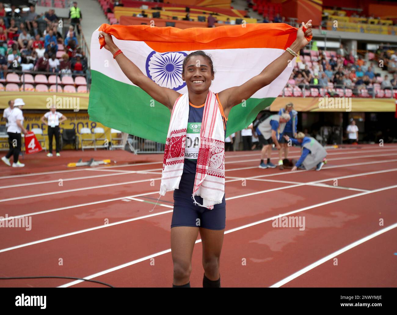 Hima Das (IND) poses with the Indian flag after winning the women's ...