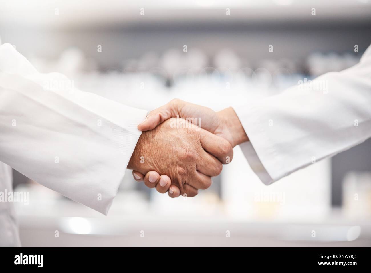 Closeup, handshake and doctors with collaboration, research and ...